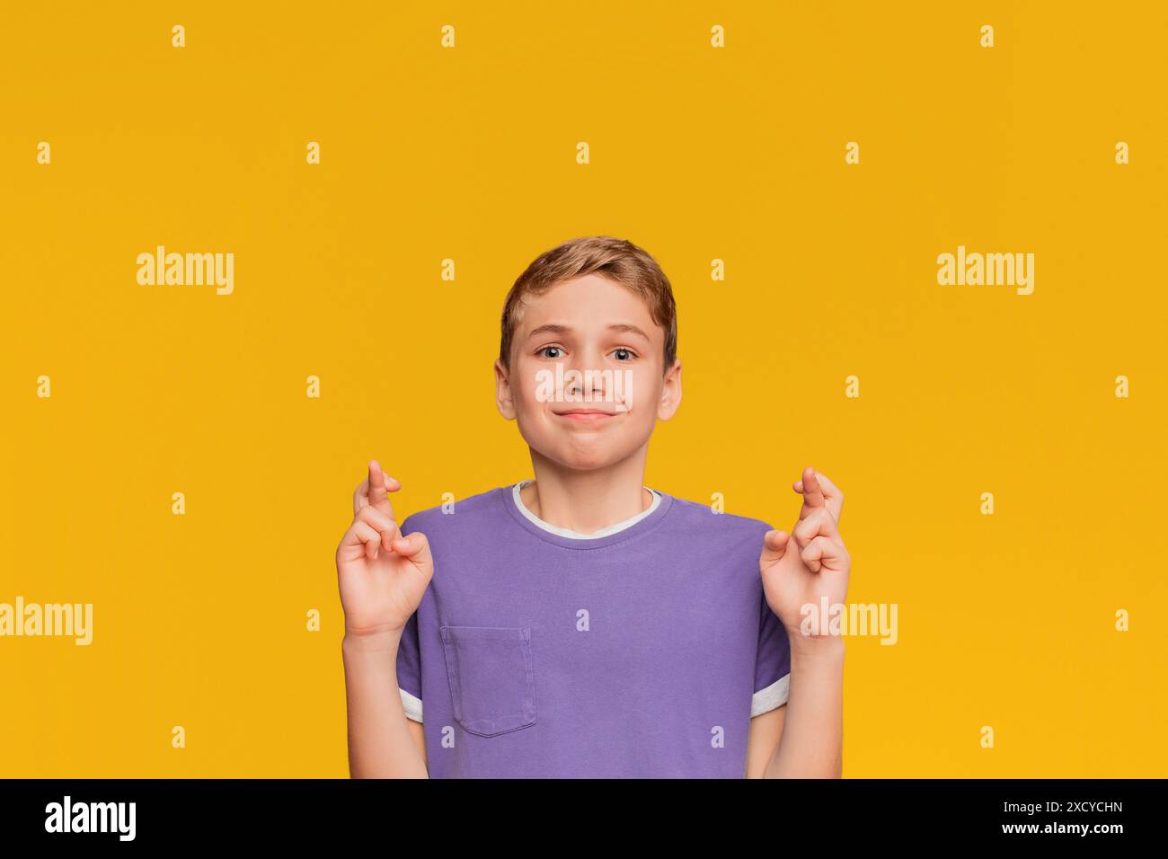 Teenager crossing fingers wishing, praying for miracle Stock Photo - Alamy