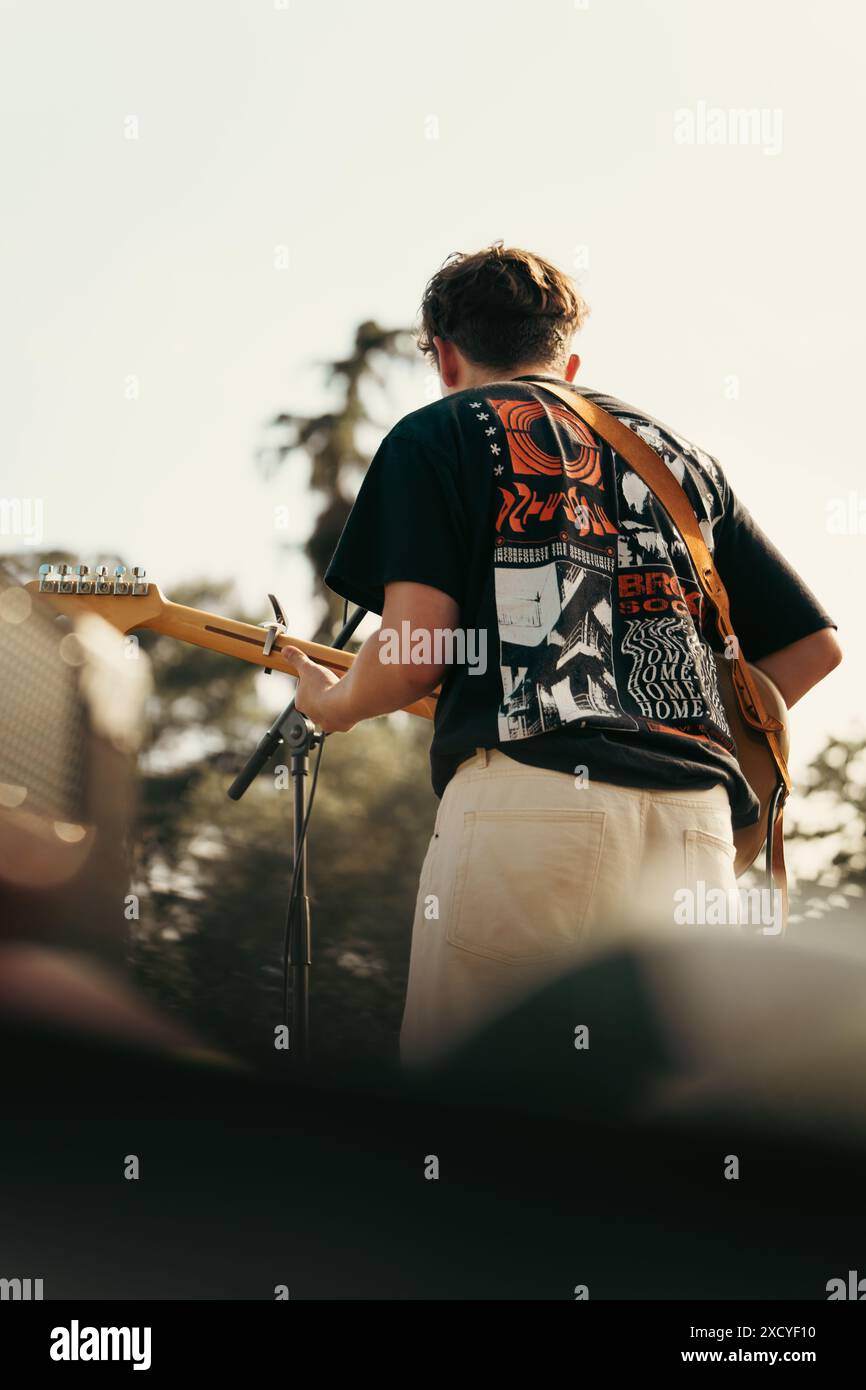 Back view of a rock band member performing an outdoor concert Stock ...
