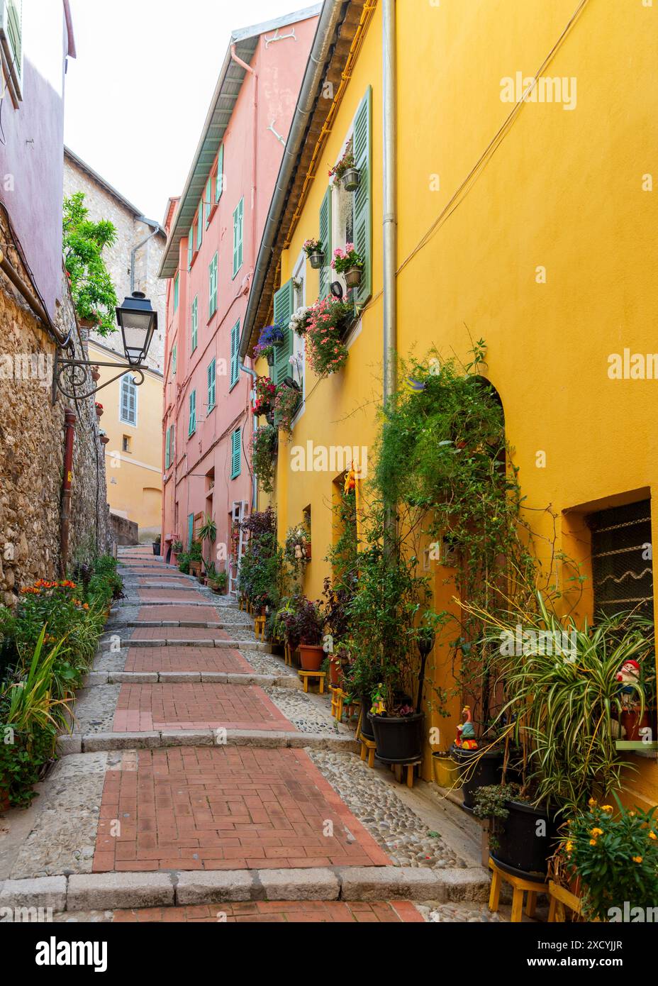 View down very pretty and colourful alley/street in Menton, France ...