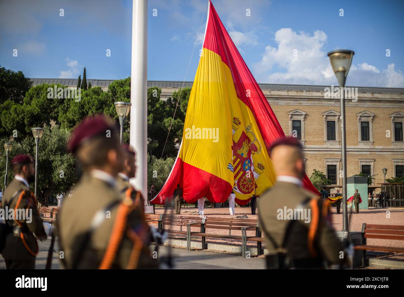 Members of the Spanish army hold a giant Spanish flag in their arms ...
