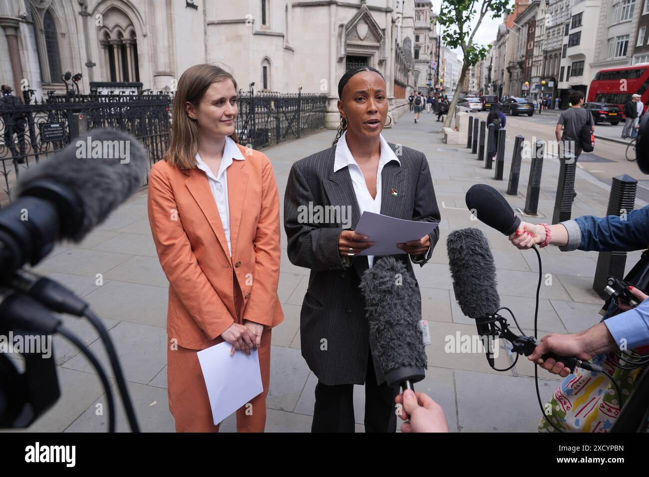 Ella Janneh (right) speaks to the media outside the Royal Courts of ...