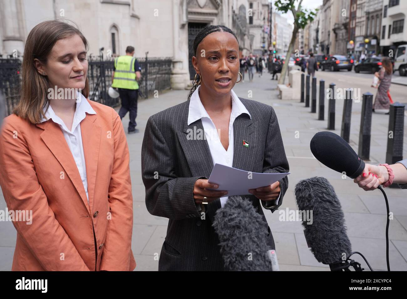 Ella Janneh (right) speaks to the media outside the Royal Courts of ...