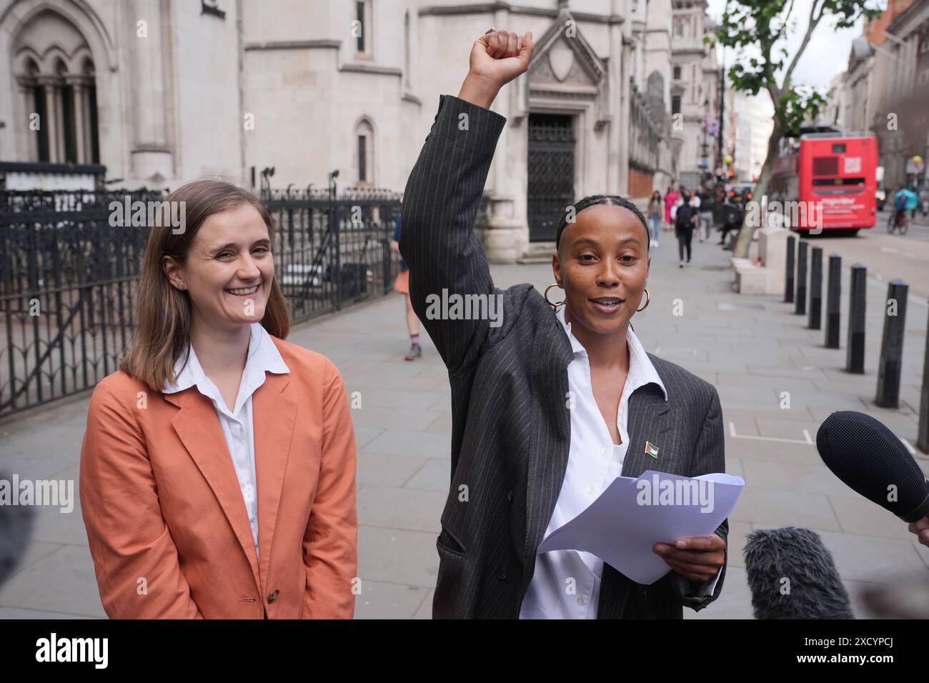 Ella Janneh (right) speaks to the media outside the Royal Courts of ...
