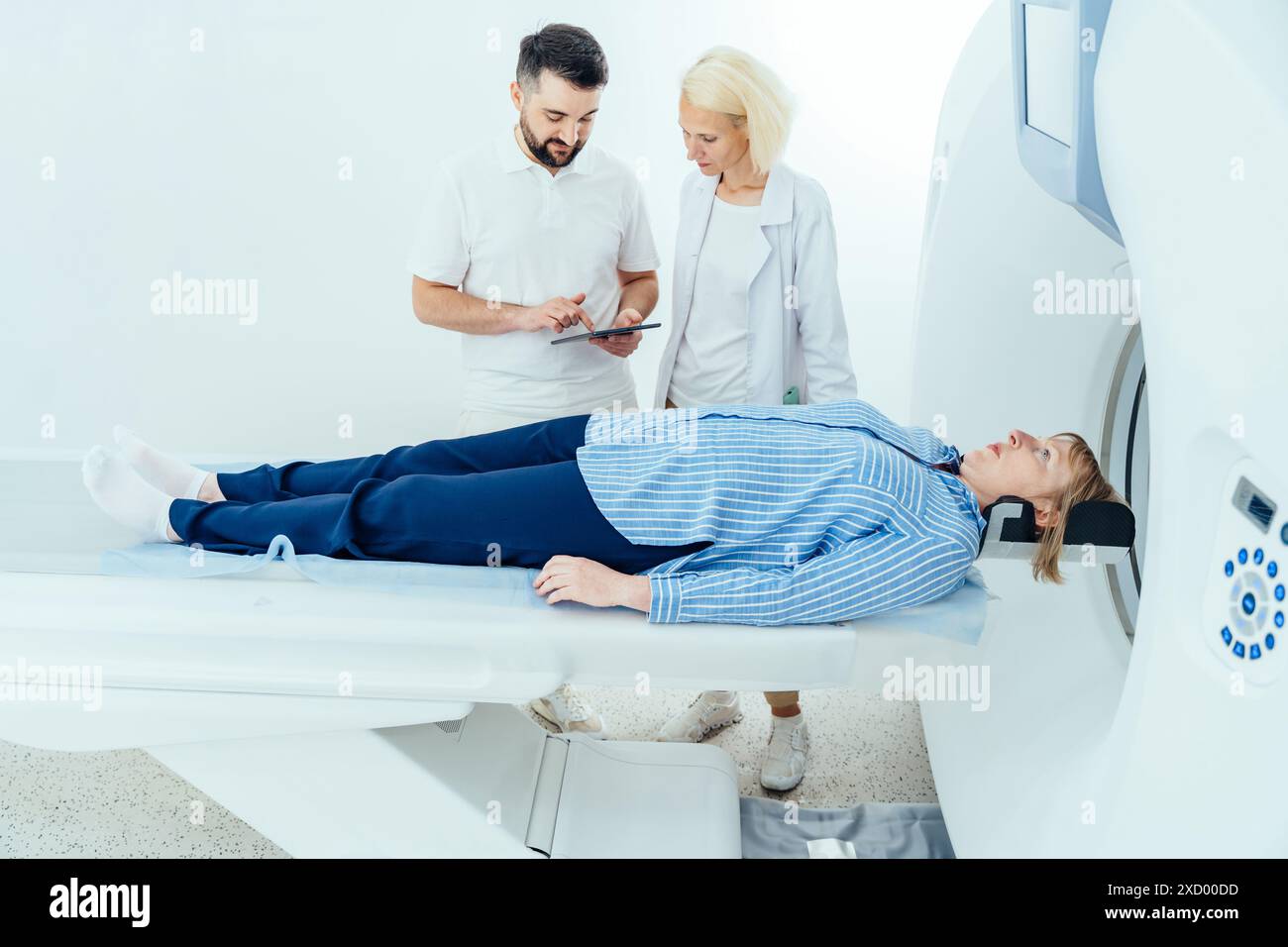 Doctors preparing patient for MRI scan. woman doctor consulting talk ...