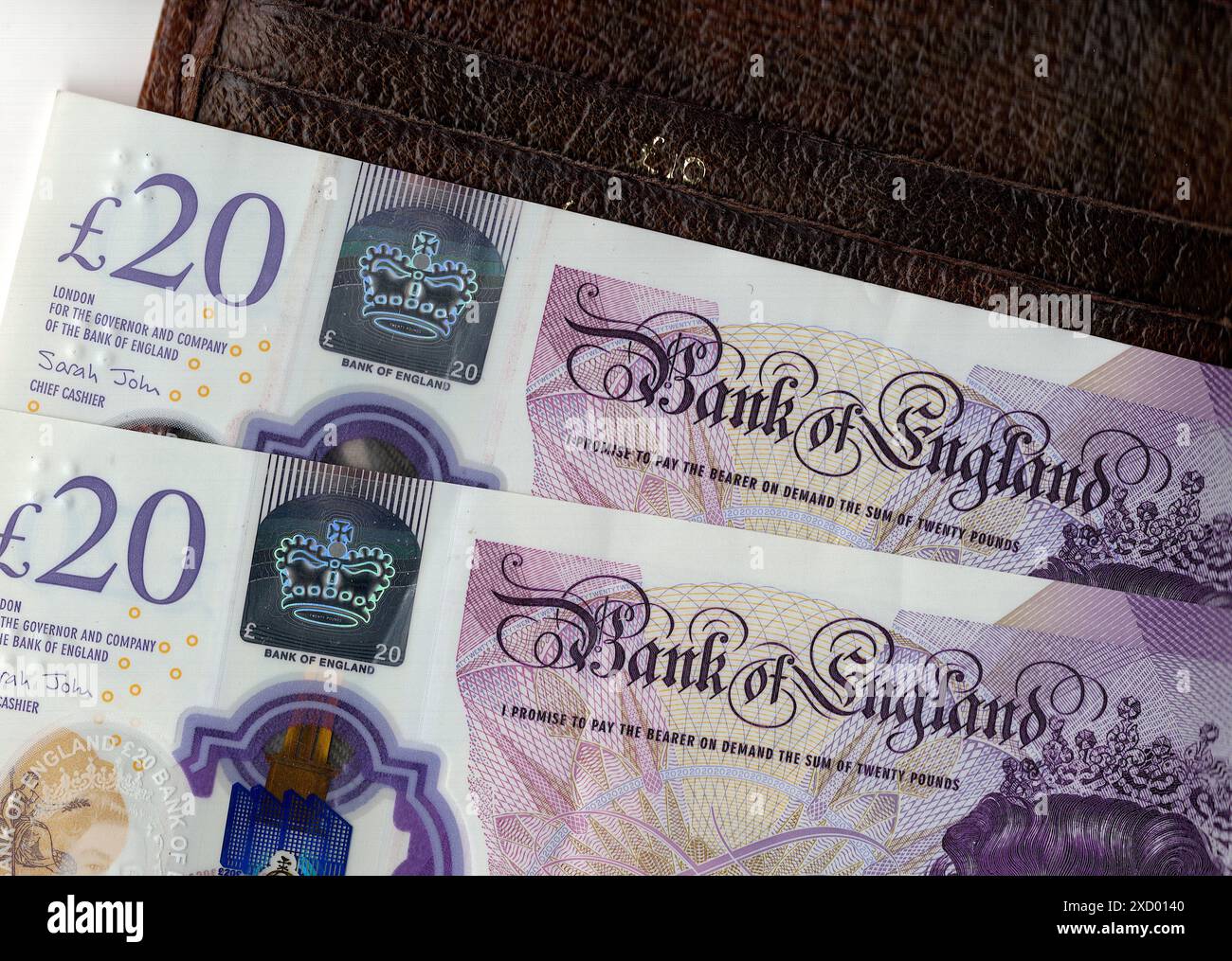 A leather wallet and modern polymer banknotes from the United Kingdom ...