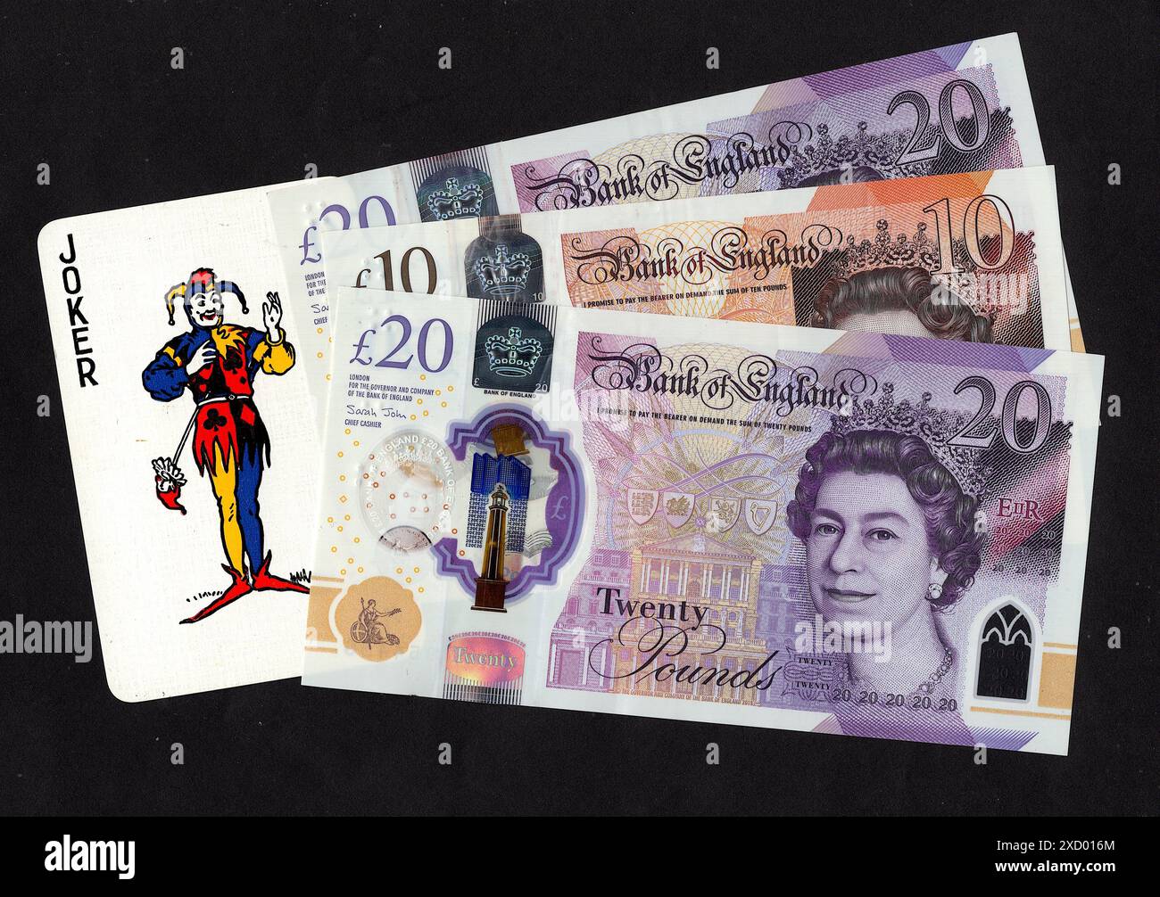 A joker playing card and modern polymer banknotes from the United ...