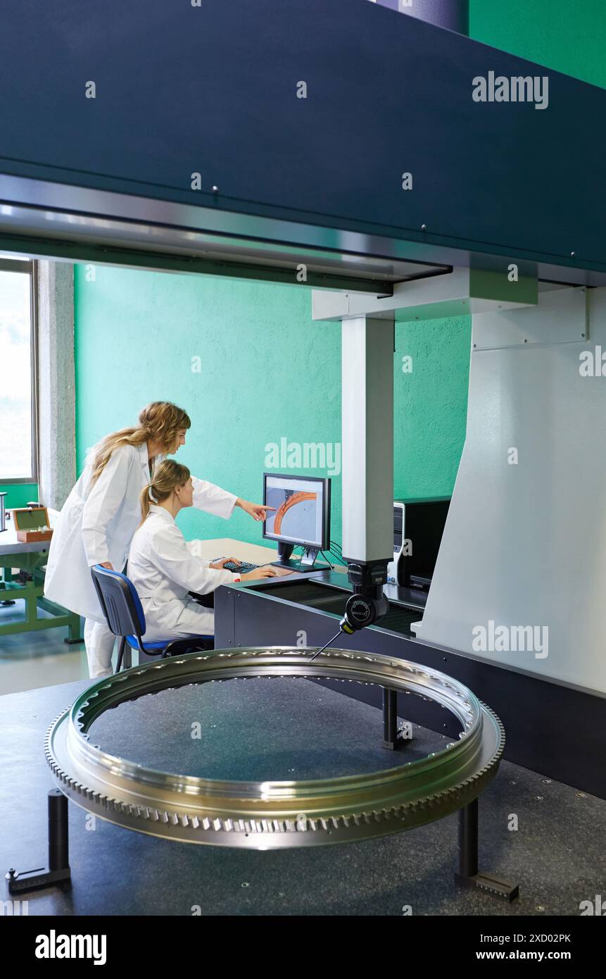 Technicians inspecting aircraft component. Measurement of a piece in ...