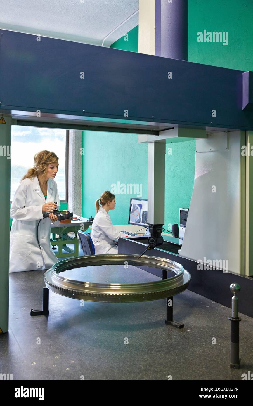 Technicians inspecting aircraft component. Measurement of a piece in ...