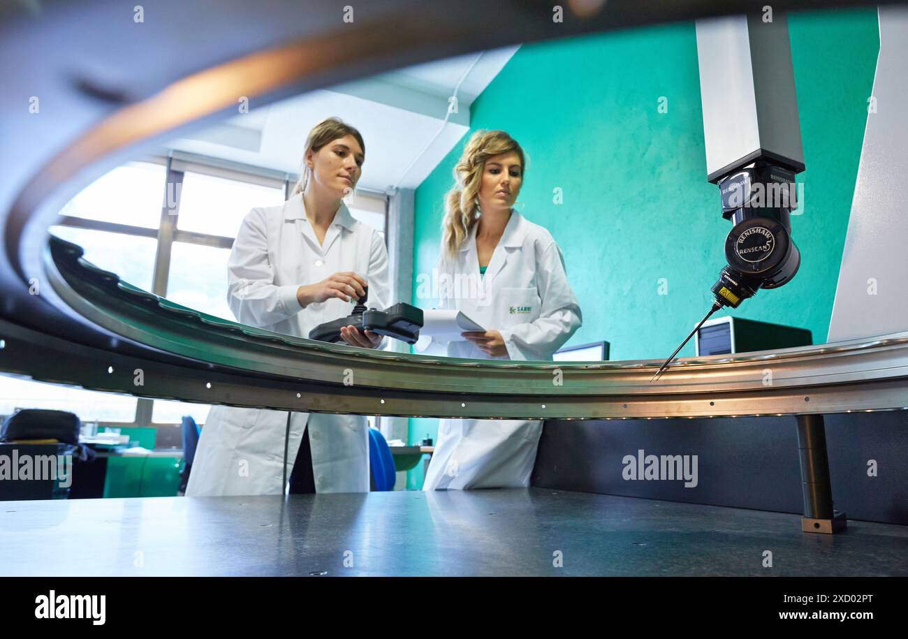 Technicians inspecting aircraft component. Measurement of a piece in ...