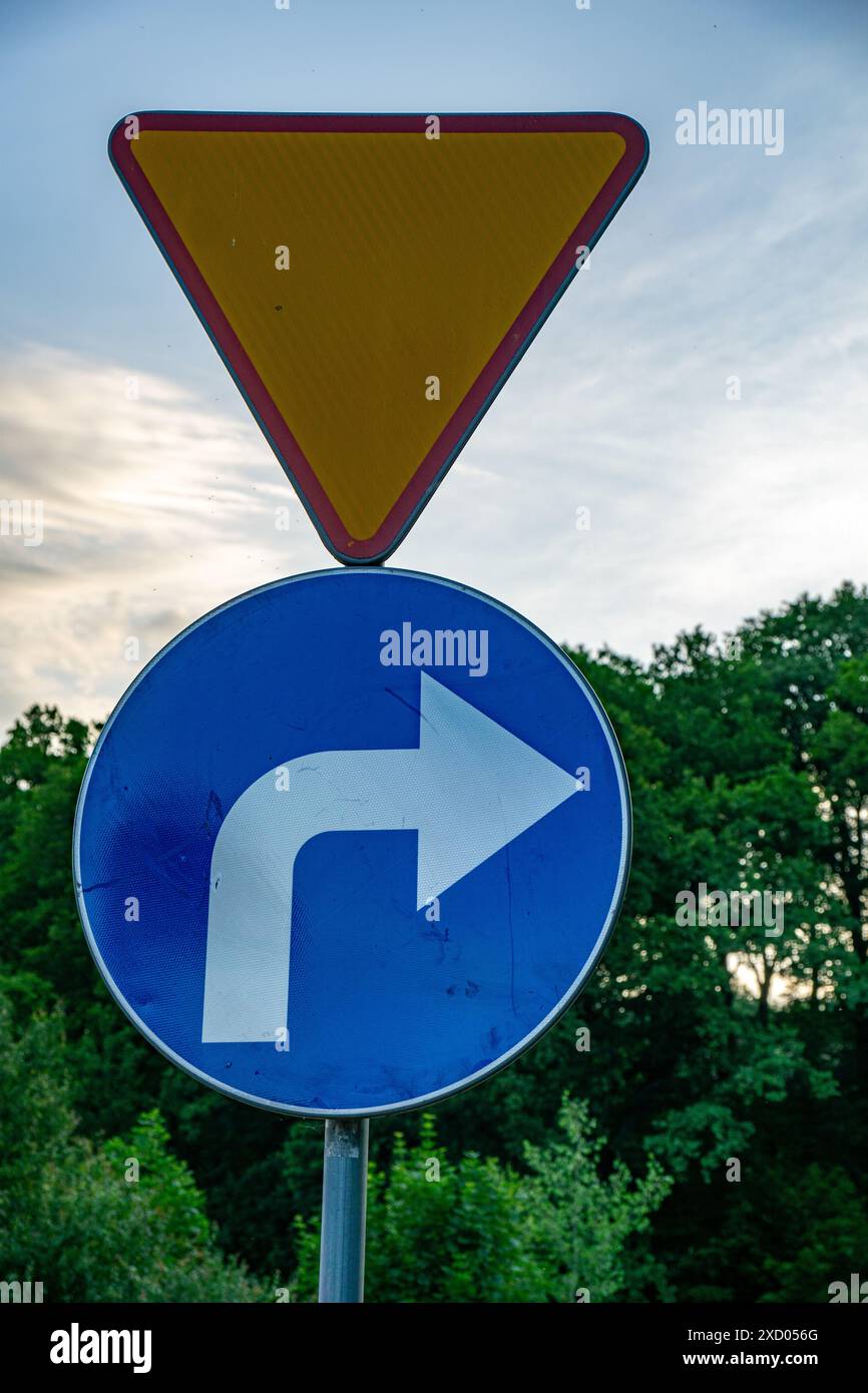 A Right Turn Warning Sign With a Yield Sign Above It Stock Photo - Alamy
