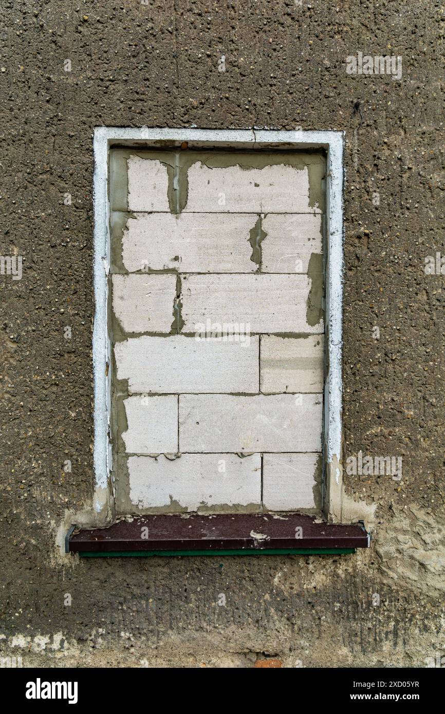 Brick up Window Frame on a Concrete Wall eviction concept Stock Photo - Alamy