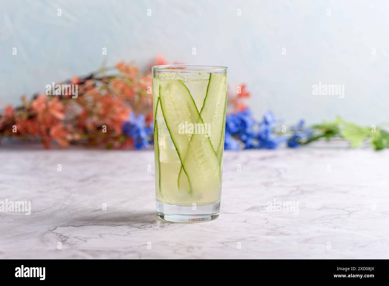 A glass of cucumber non-alcoholic mocktail made from lemonade and thinly sliced cucumbers ...