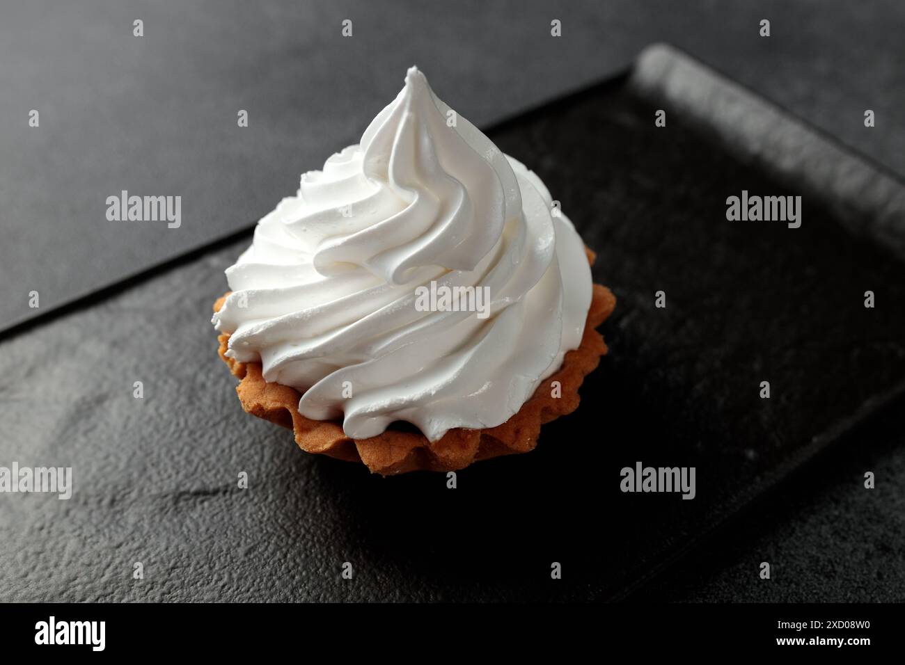 The sand basket is decorated with a high peak of protein cream. A tasty ...