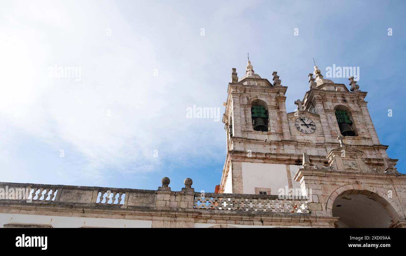 Historic Stone Clock Tower of Nazare Church Against Blue Sky. Twin ...