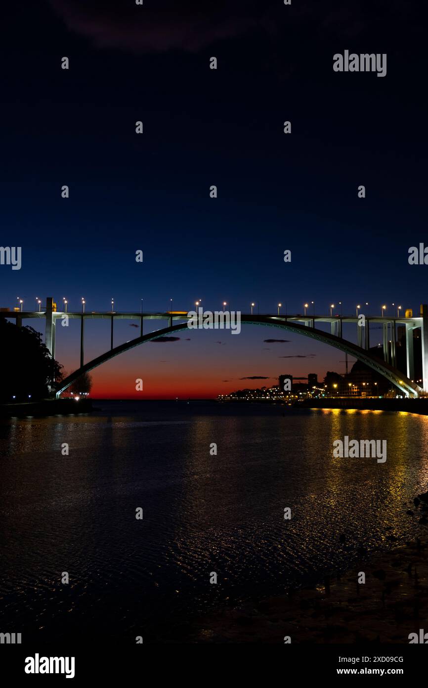 Illuminated Arrabida Bridge over Douro River at Dusk in Porto, Portugal ...