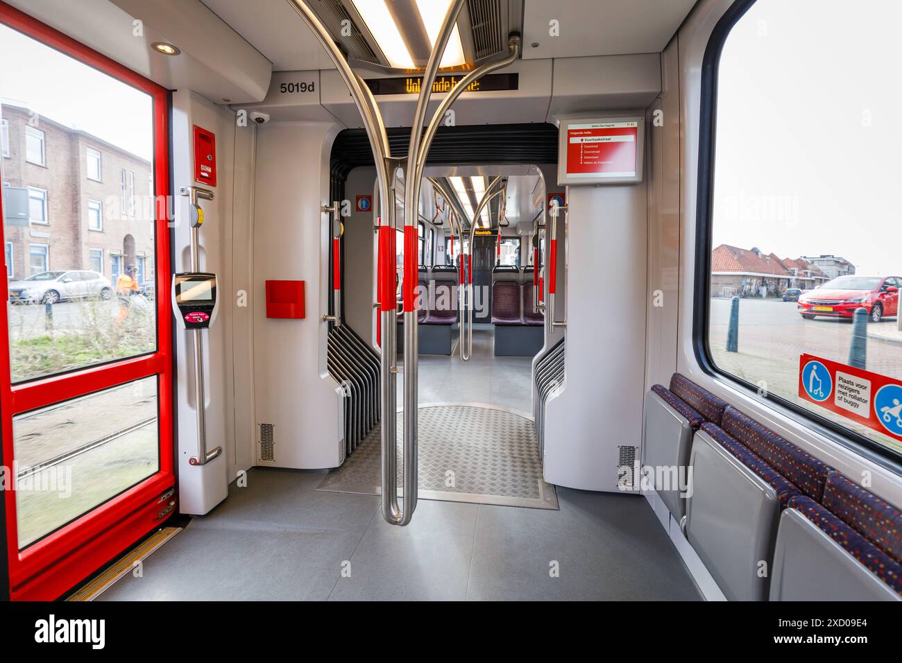 Interior of the empty Dutch tram, empty seats, white walls, big windows ...