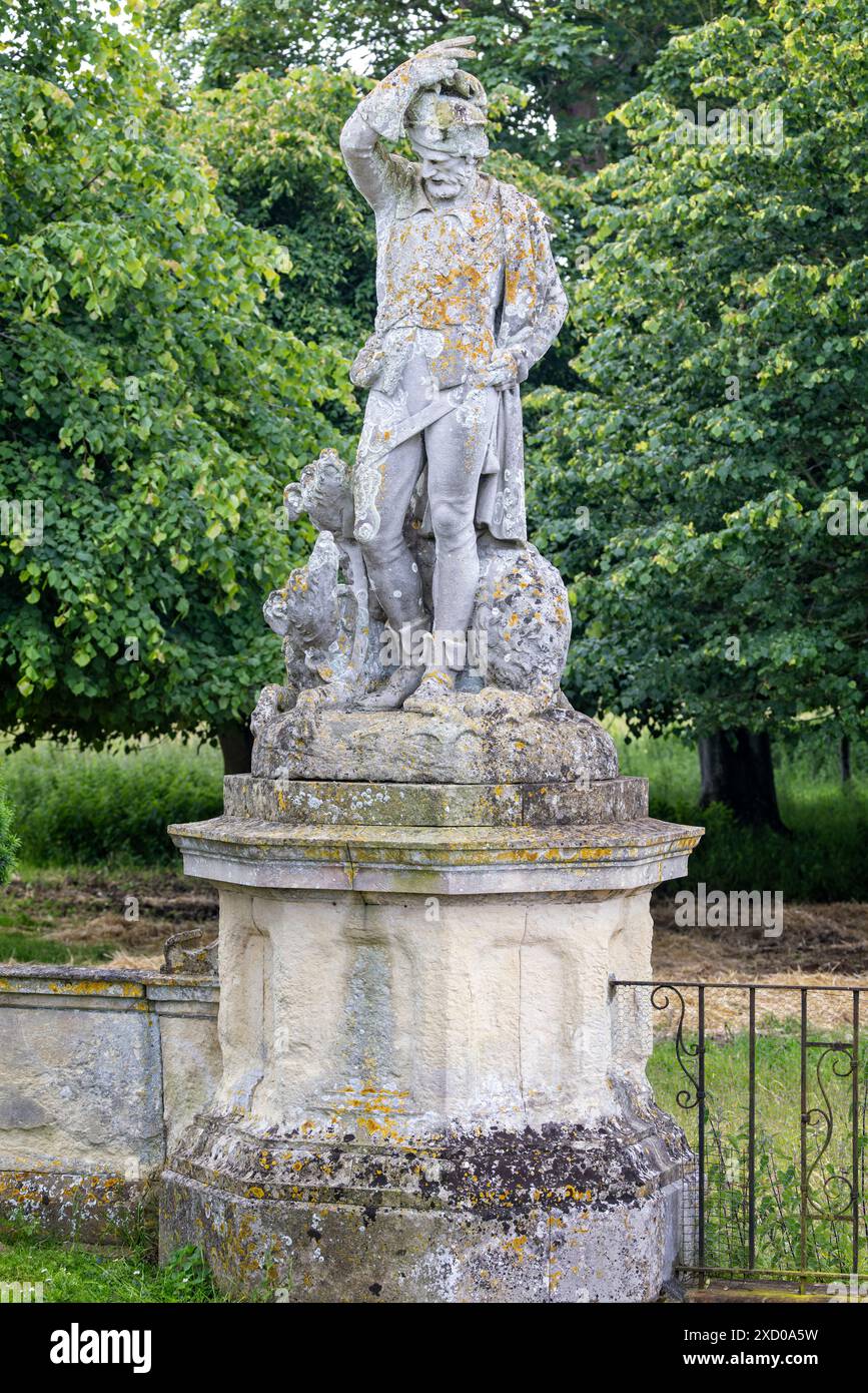 Stone sculpture of hunter with dogs in the gardens at Somerleyton Hall ...