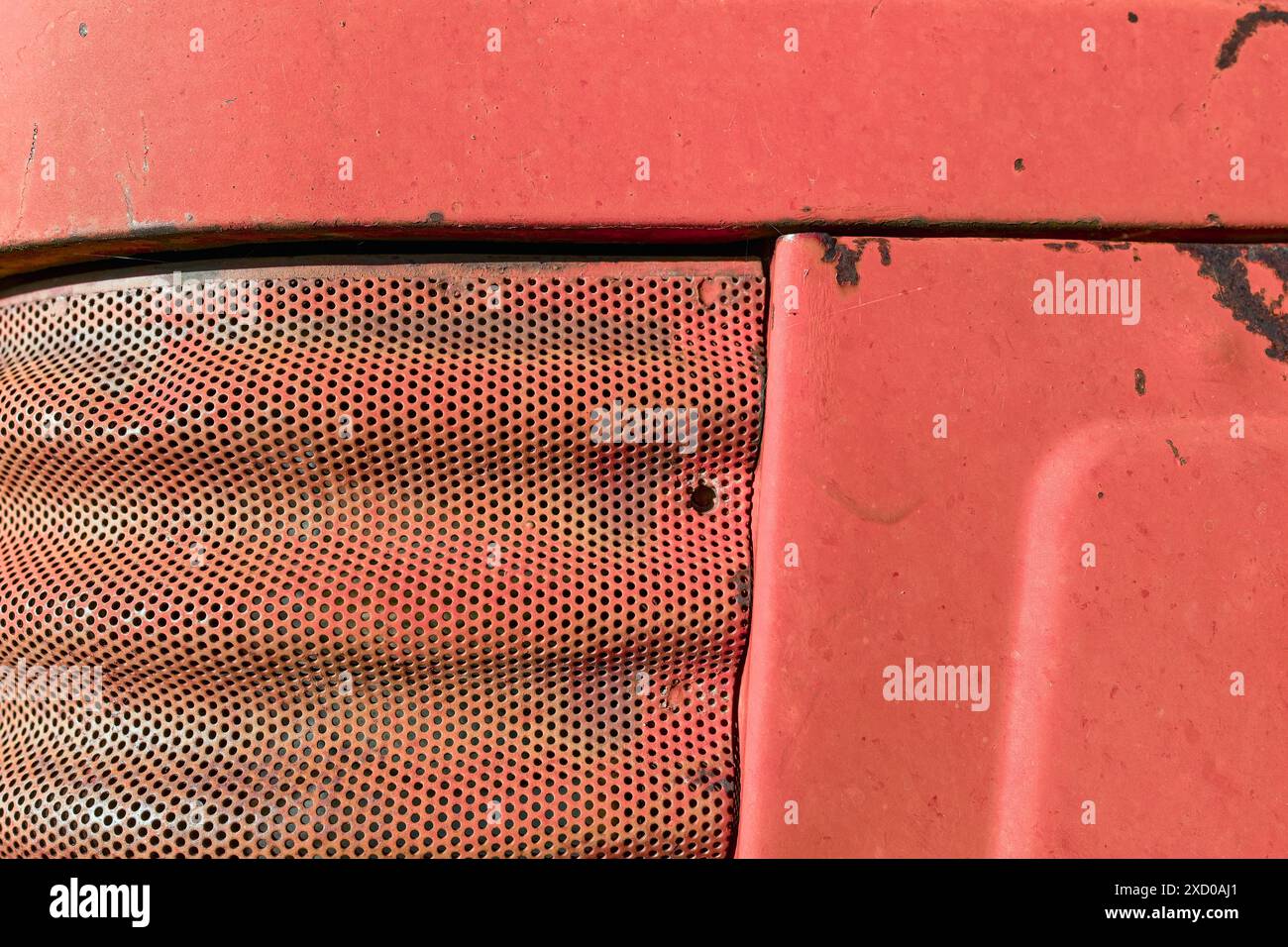 The detail of the perforated side vent and metal body of an orange farm ...