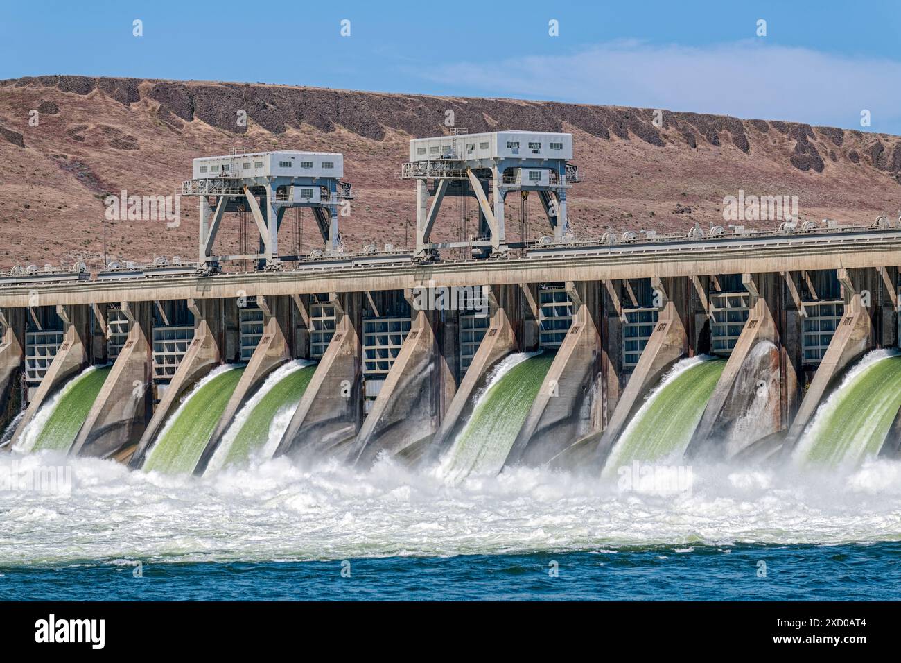 Waters of the Columbia River rush through the spillway gates below the ...