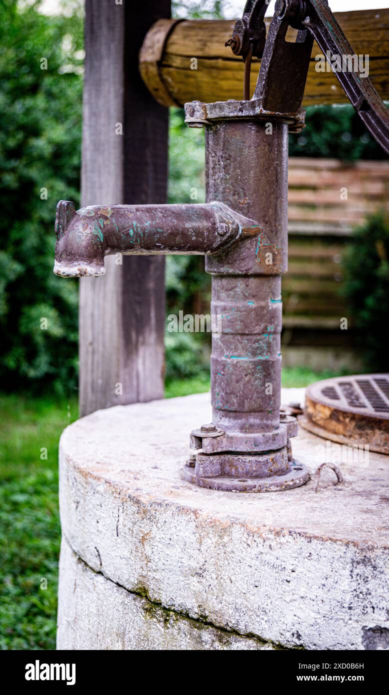 Rustic Hand Pump on a Well in a Lush Garden Stock Photo - Alamy