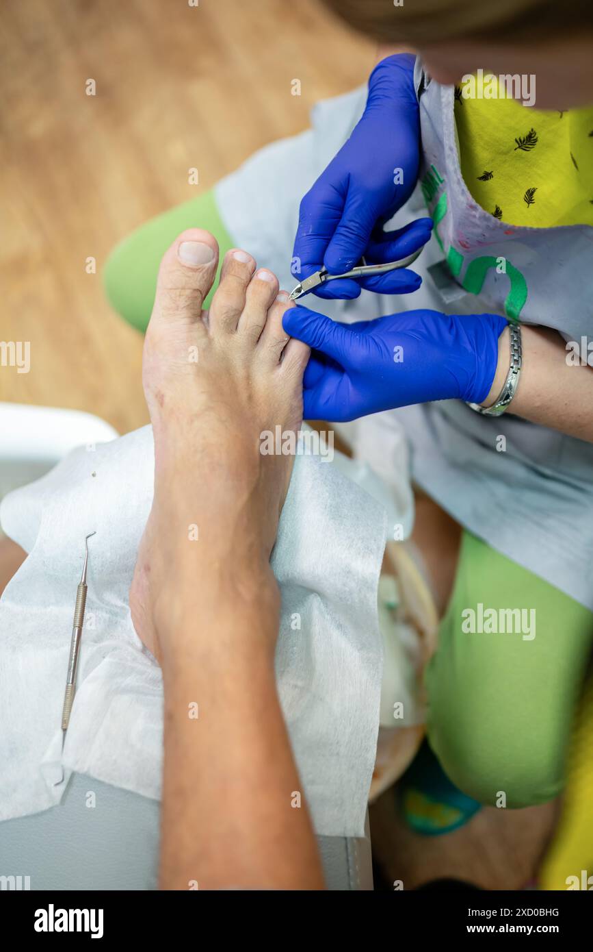 concept of male pedicure, foot pedicure, cosmetologist makes classic ...