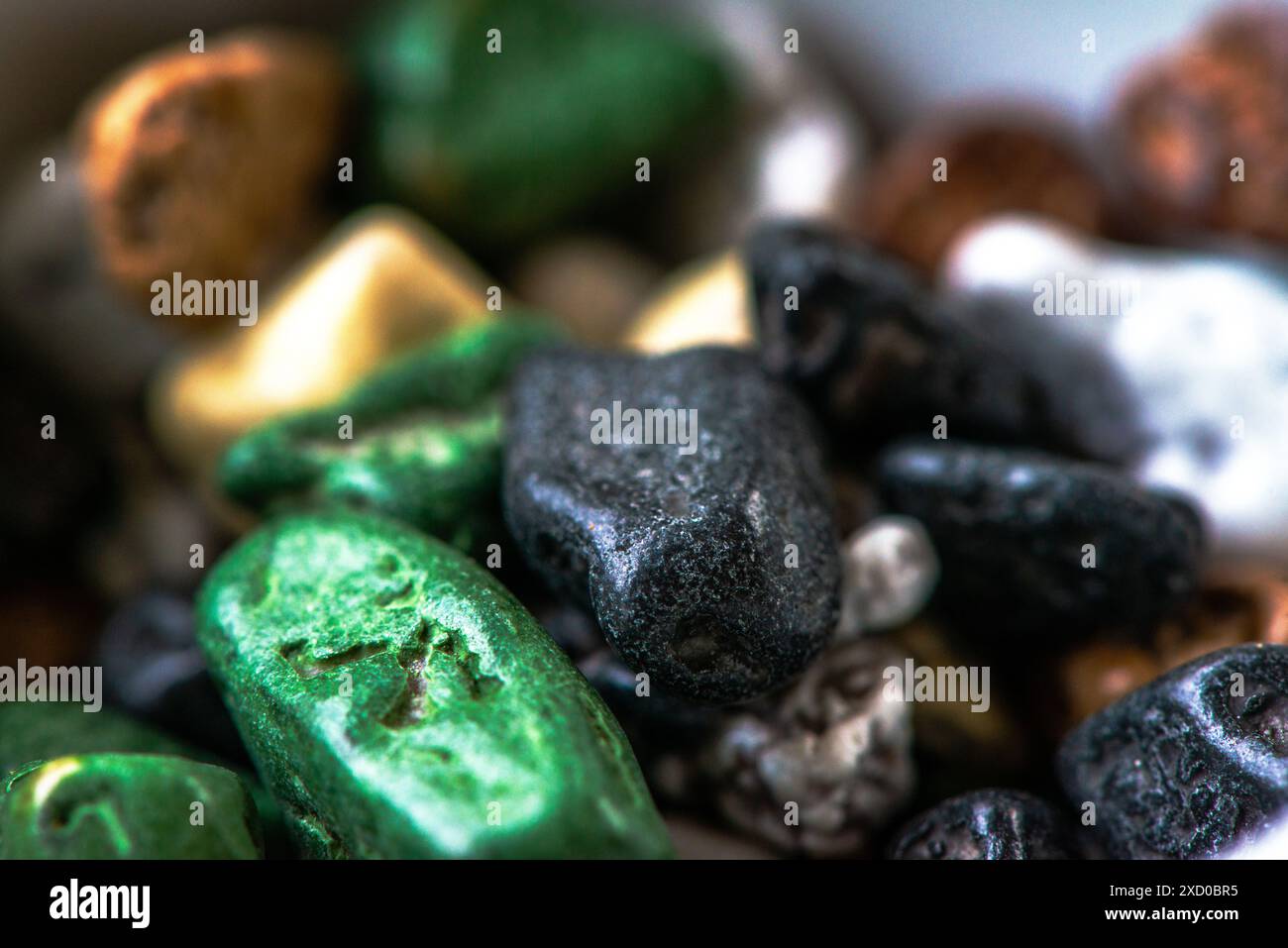 A detailed macro photo of colorful pebble chocolate, capturing the ...
