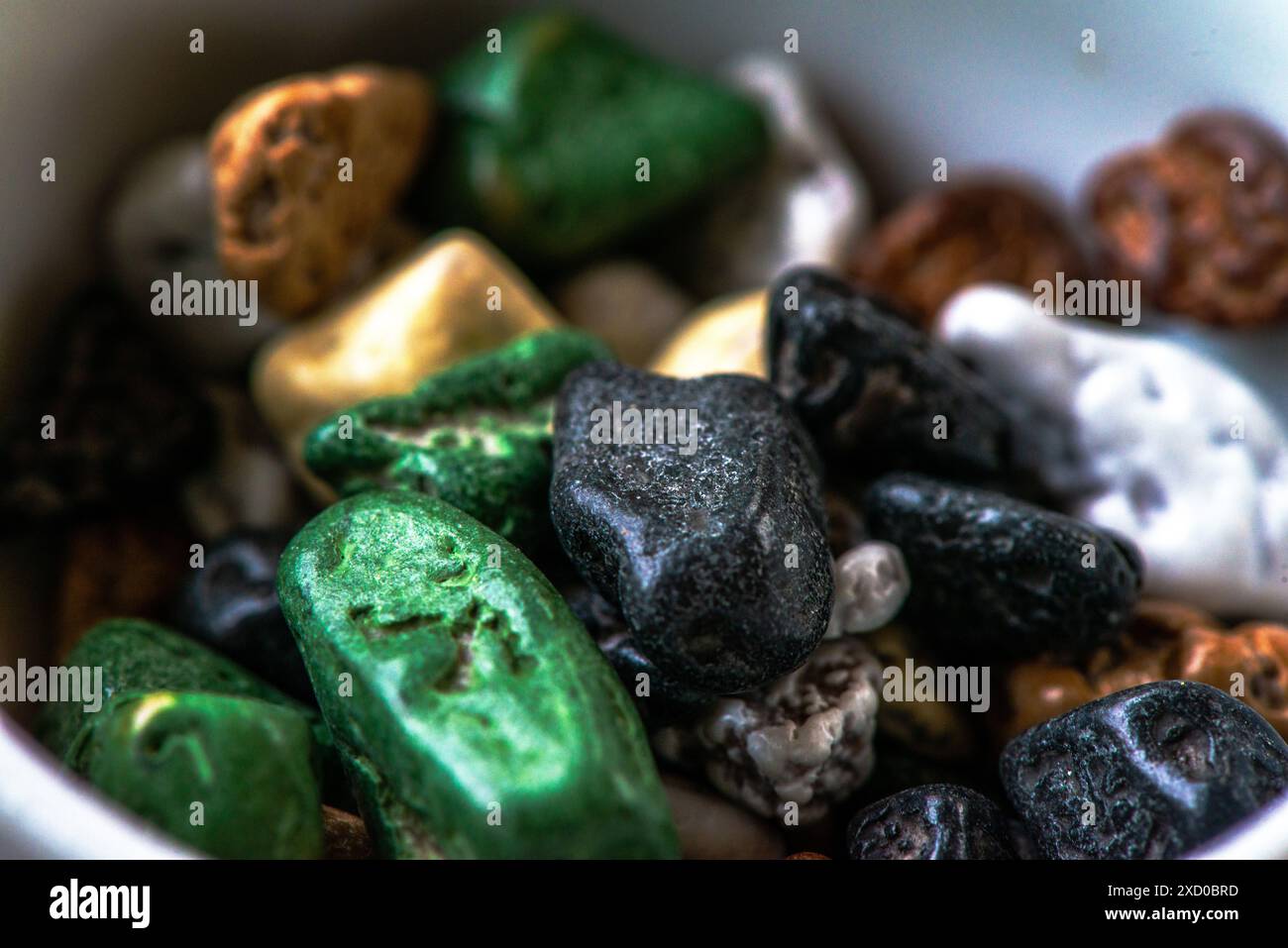 A detailed macro photo of colorful pebble chocolate, capturing the ...