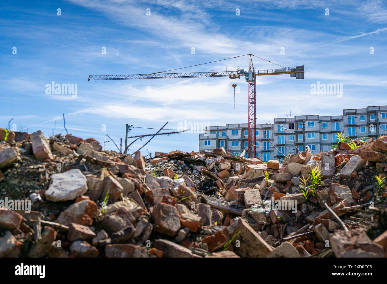 Construction Debris Pile With Crane and New Building in Background ...