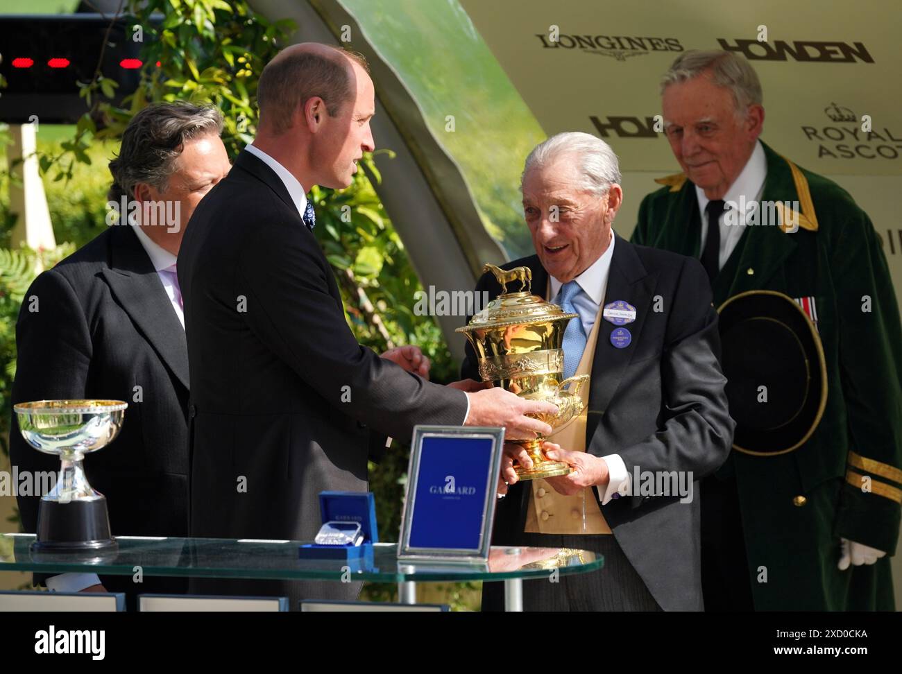 The Prince of Wales presents owner Derrick Smith with the trophy after ...