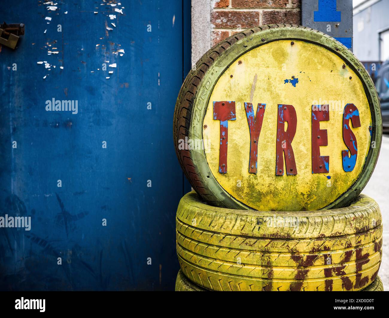 STACK OF YELLOW WITH BLUE ARROW TYRES TIRE RUBBER FOR AUTOMOTIVE ...