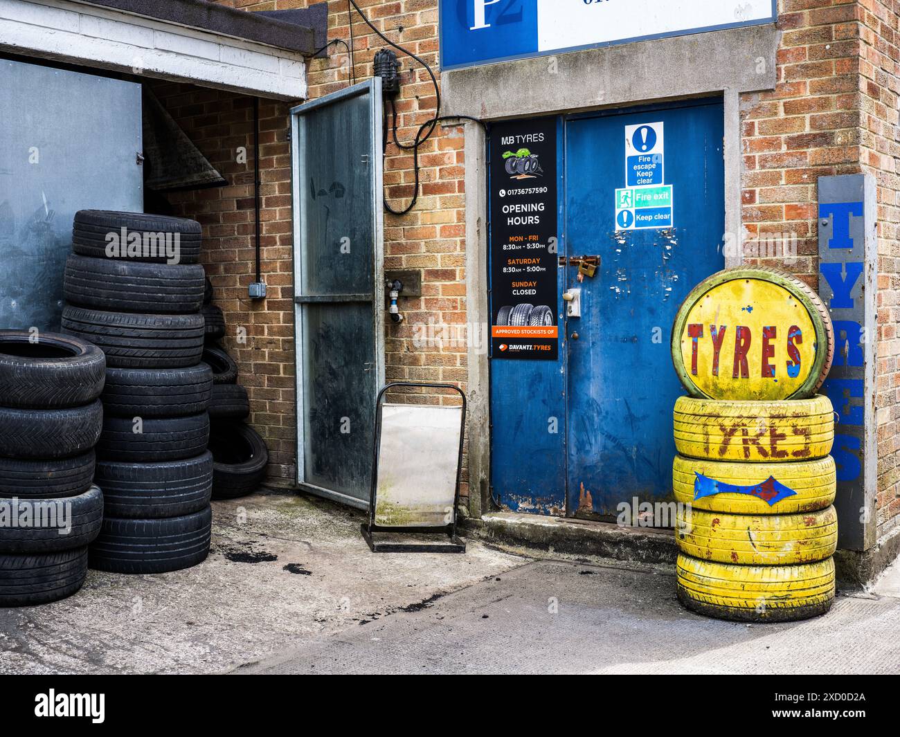 STACK OF YELLOW WITH BLUE ARROW TYRES TIRE RUBBER FOR AUTOMOTIVE ...