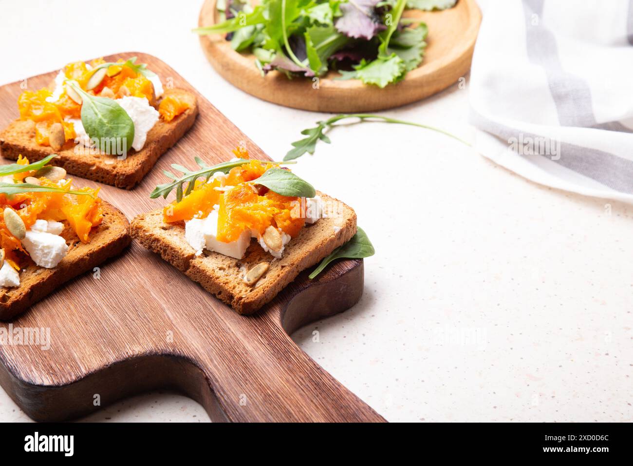 Toasted whole grain bread topped with roasted pumpkin, creamy goat ...