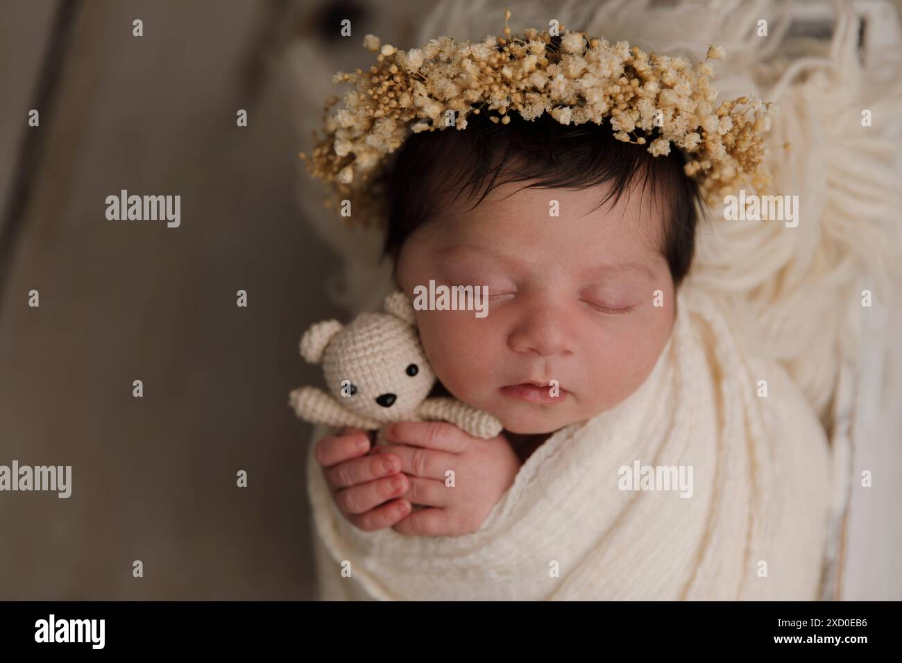Top view of a newborn baby sleeping on a bed under beige blanket and a ...