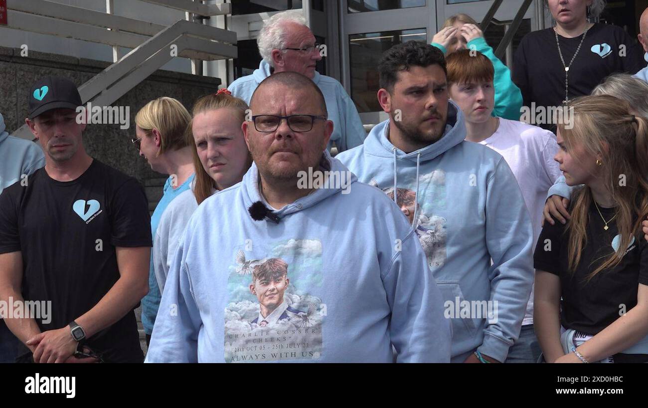 Martin Cosser (centre), surrounded by family and supporters, speaks to ...