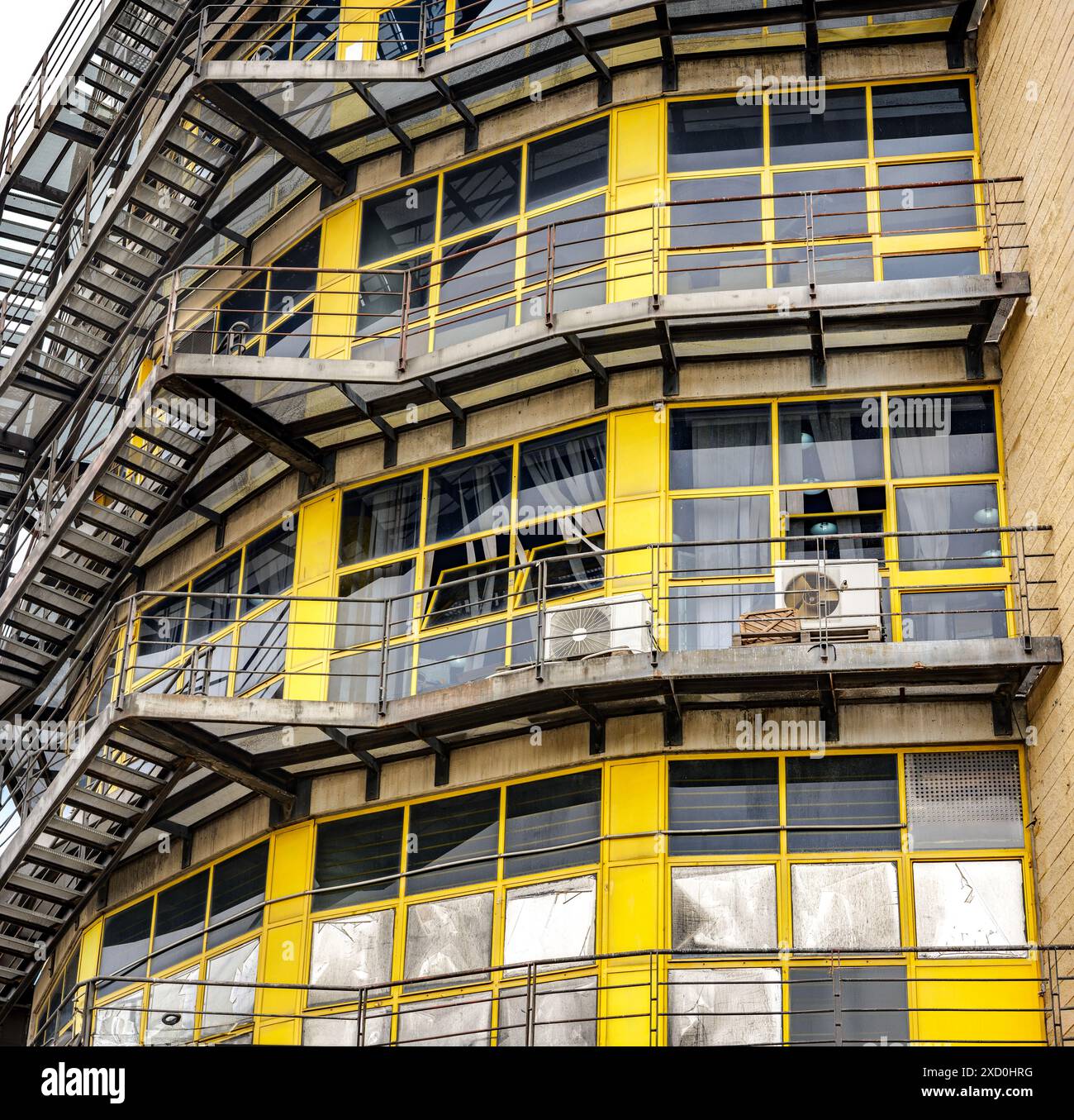 An antique industrial building featuring prominent emergency stairs and ...