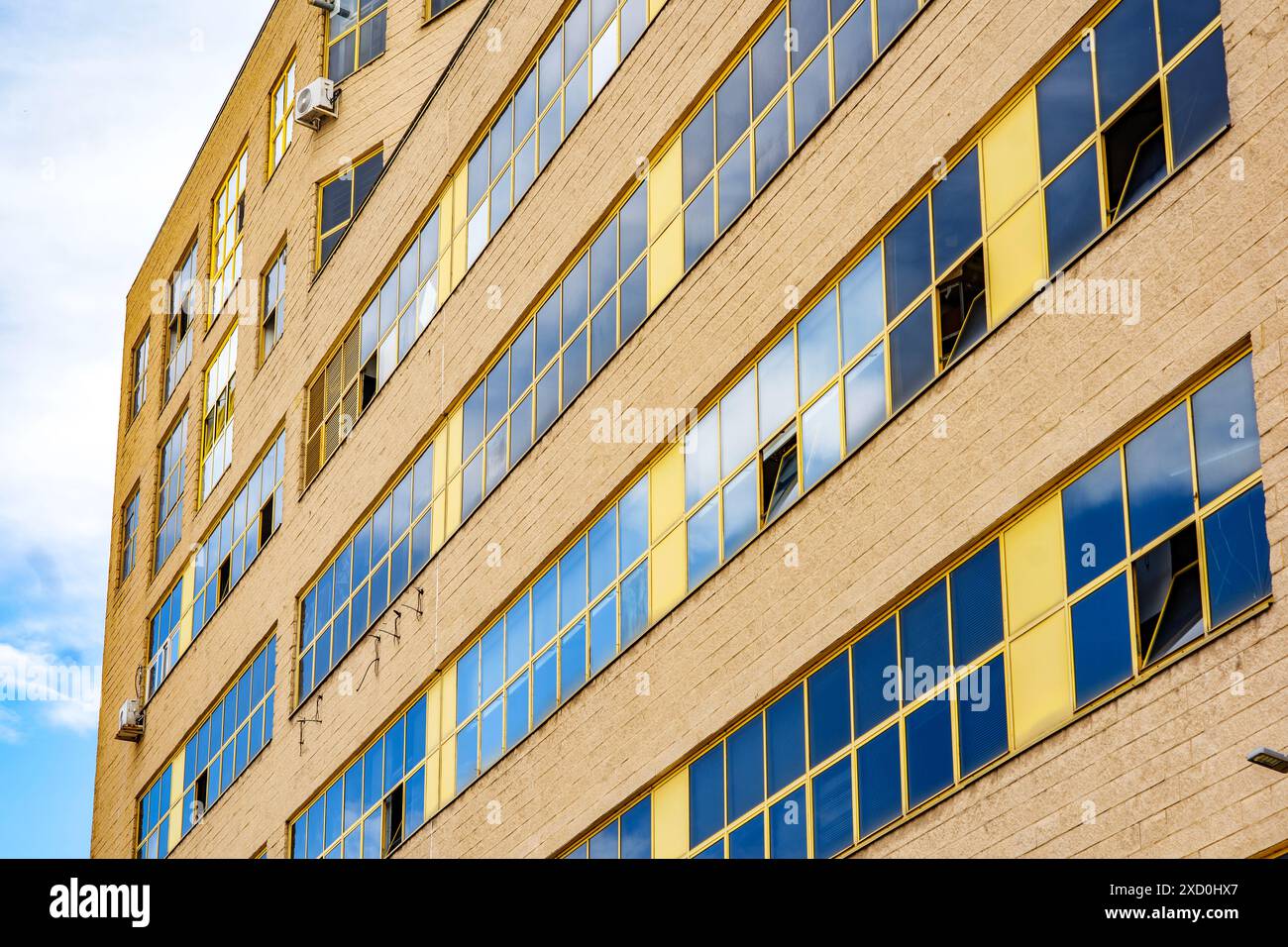An antique industrial building featuring a large facade with yellow ...
