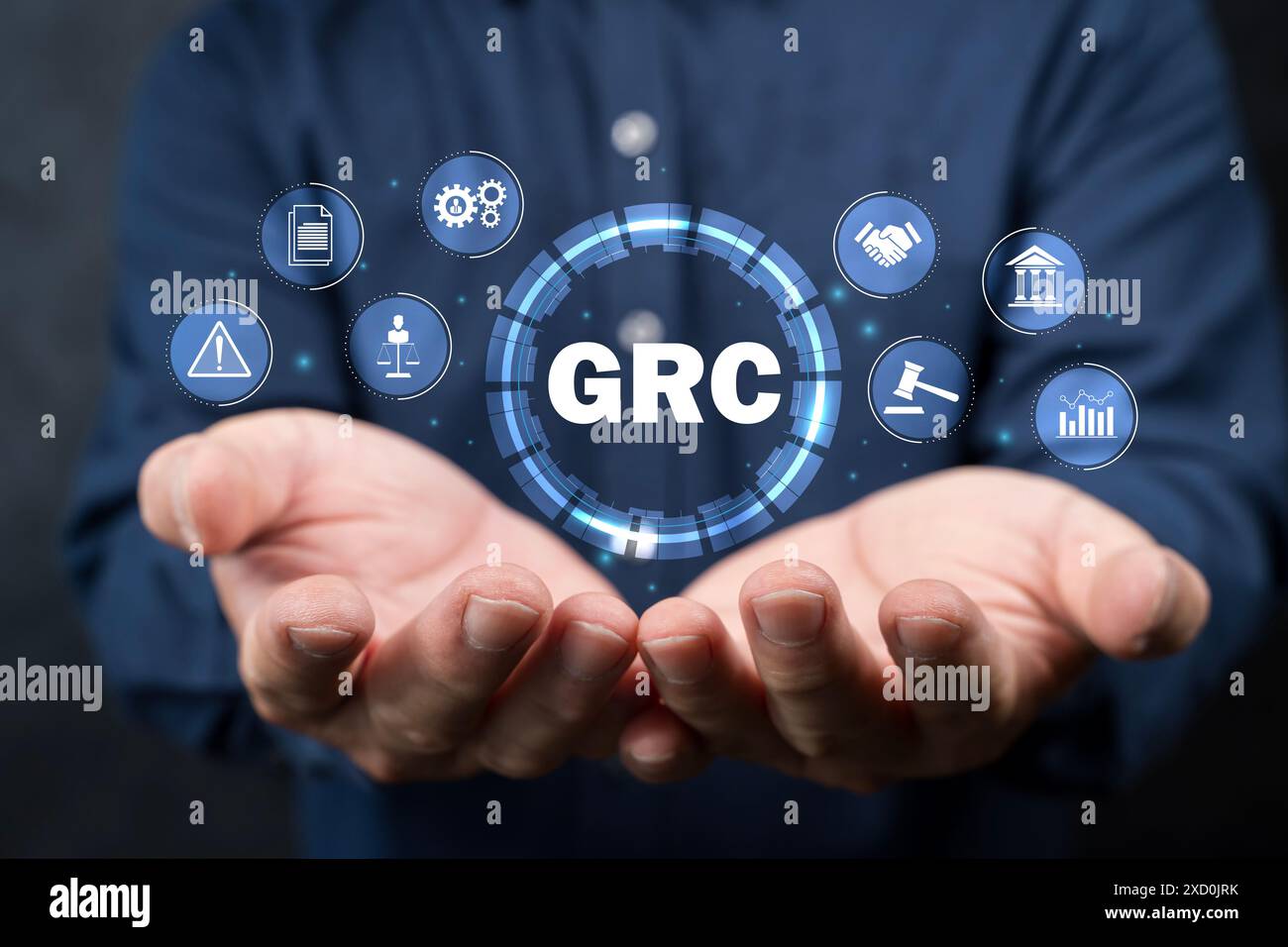 GRC, Governance Risk and Compliance concept. Businessman holding GRC icon on digital screen ...