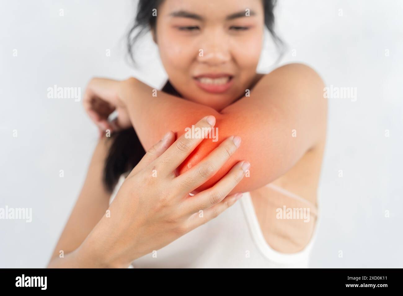Woman having elbow pain. Woman suffering from elbow pain while sitting ...