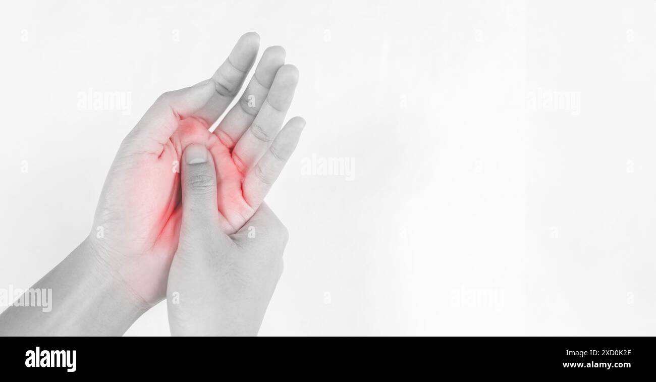 A woman massages her painful hands isolated on a white background. A ...