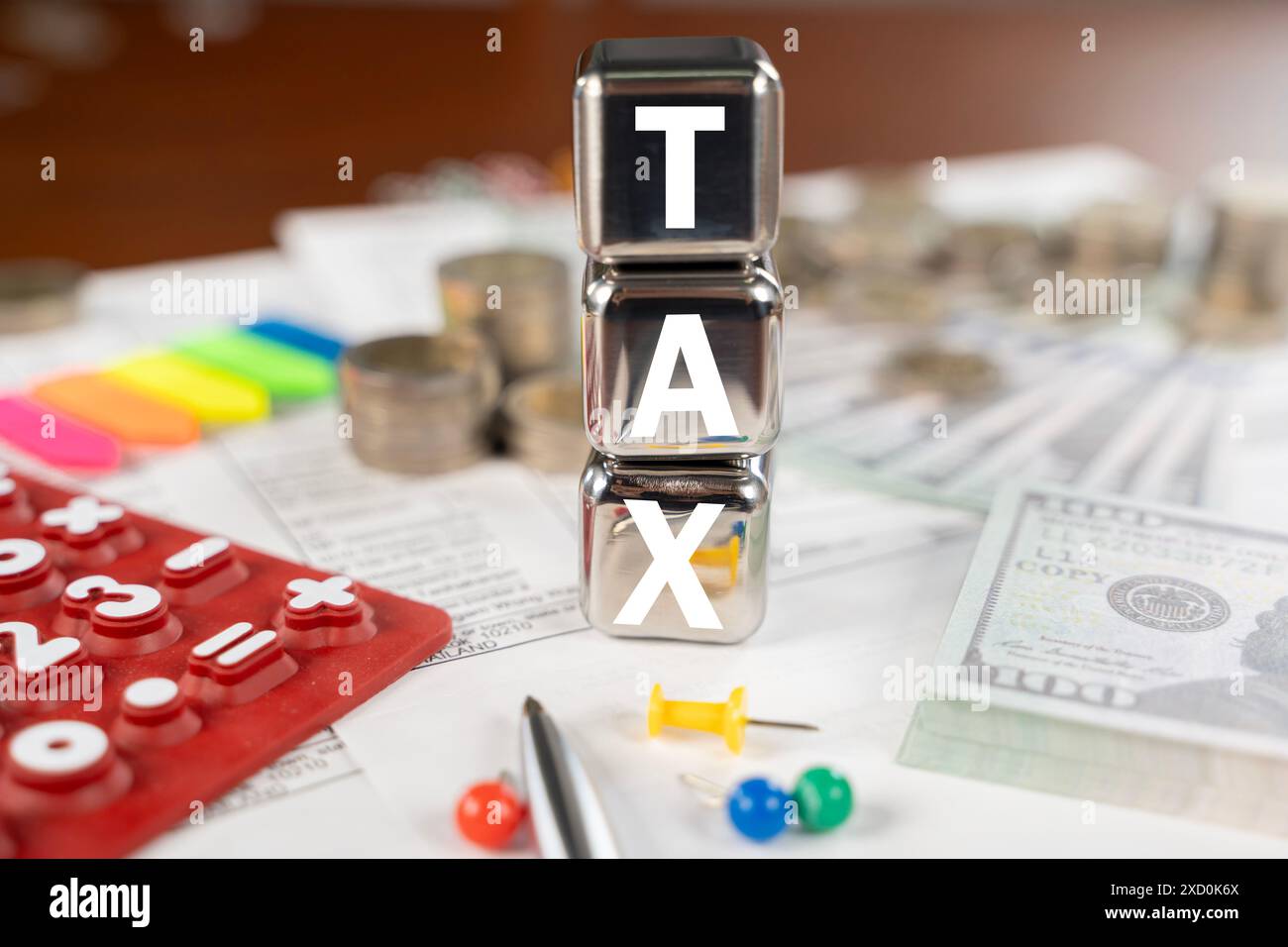 A stack of cubes with the word tax written on them. The cubes are on ...