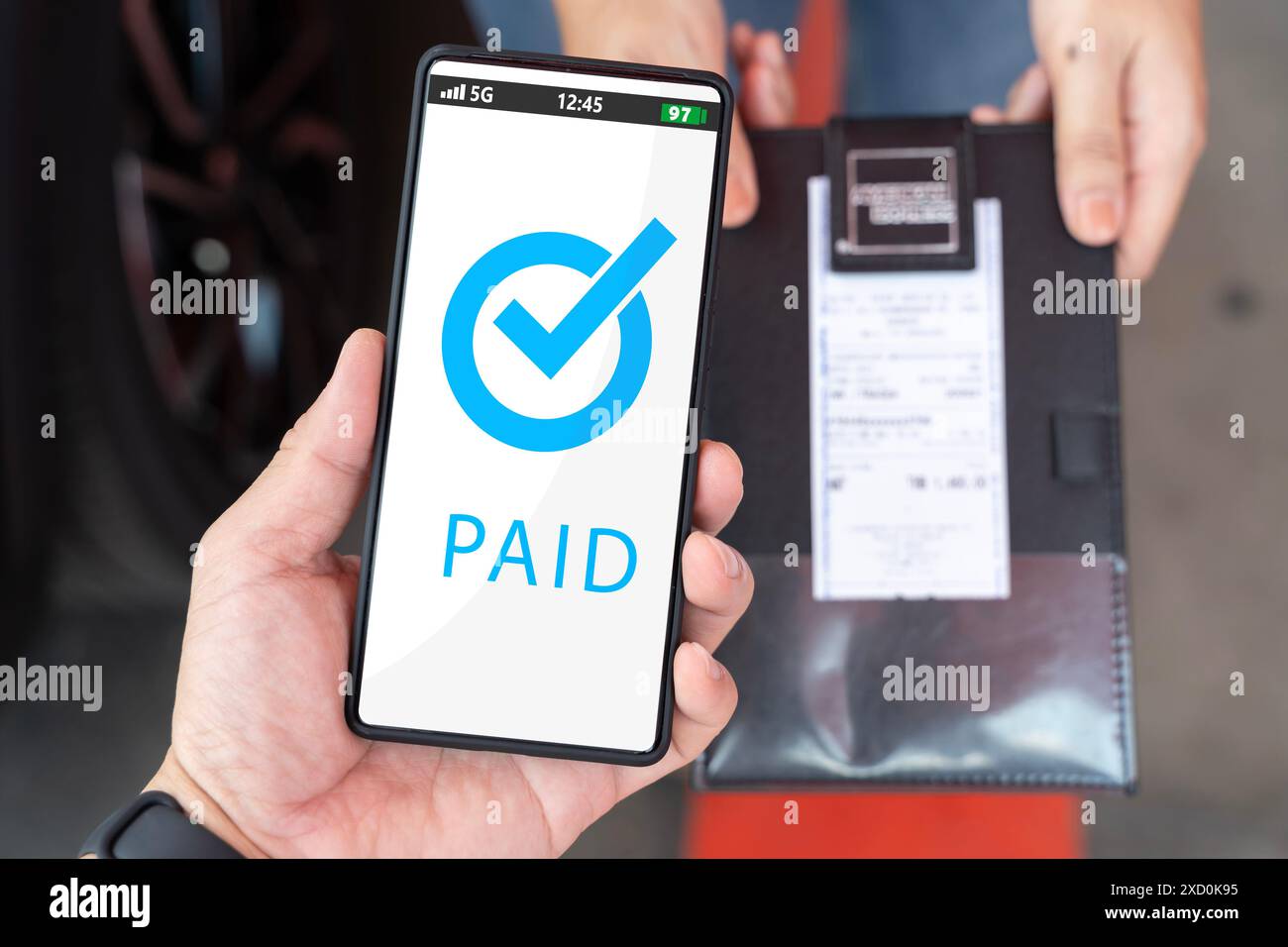 A person is paying for something with a smartphone. The phone has a ...