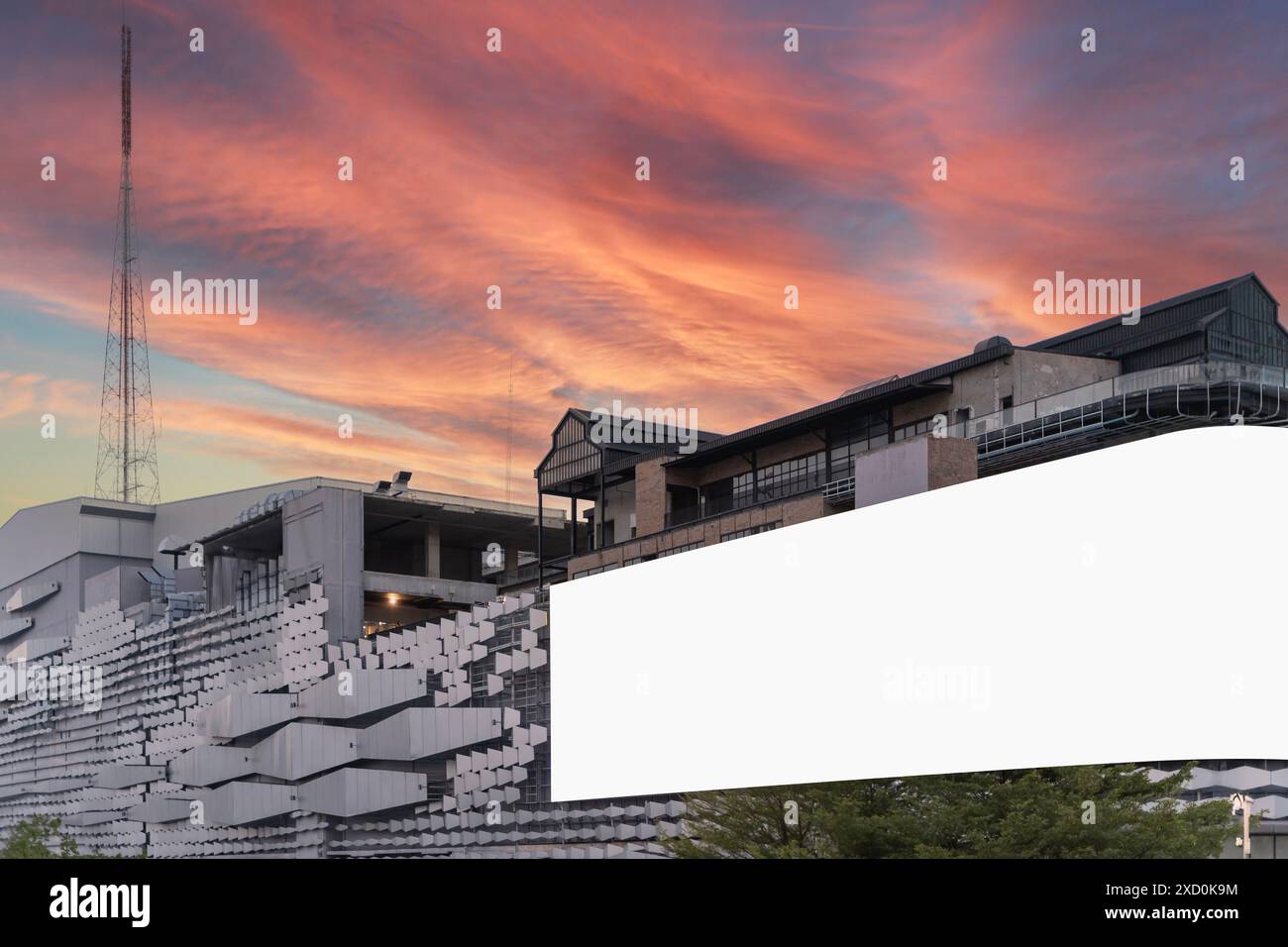 Big, horizontal, billboard on the building wall. Traffic and sky ...