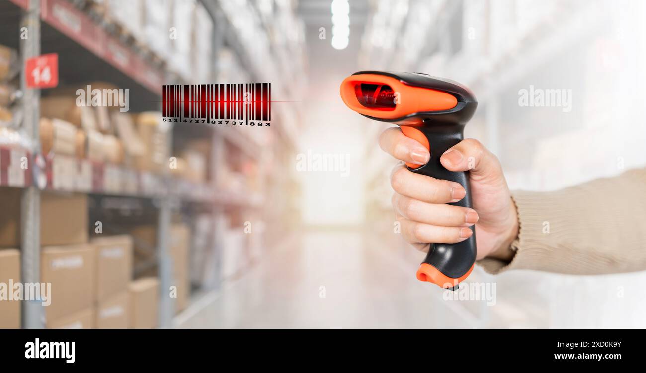 A person is holding a barcode scanner in a warehouse. A person is ...