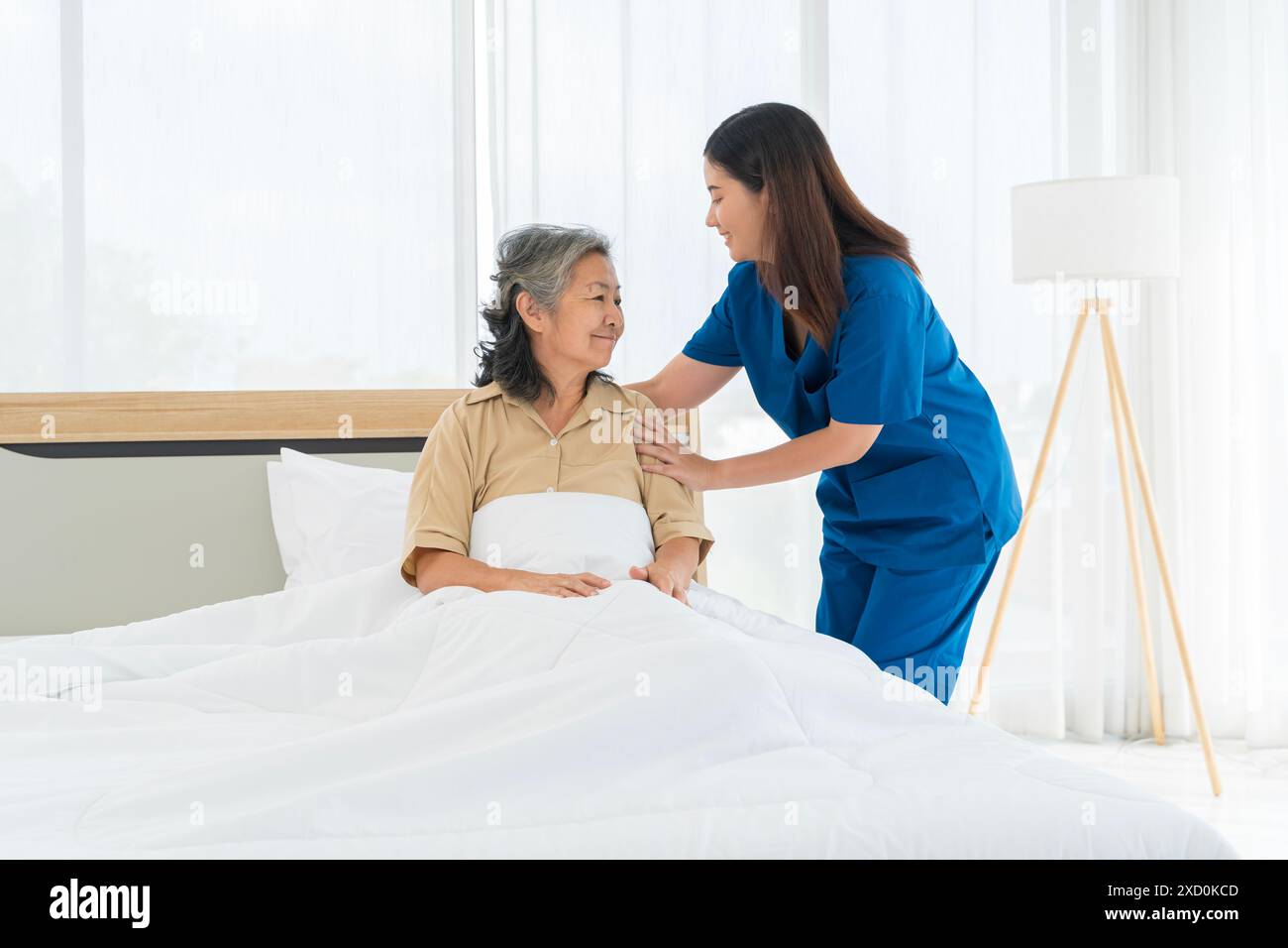 Nurse assistant concept. A woman in a blue uniform is helping an ...