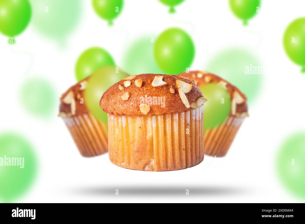 Muffins and green balloons flying on white background for birthday ...