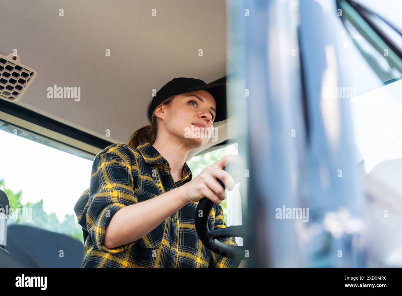 Woman driving tractor farm cabin hi-res stock photography and images ...