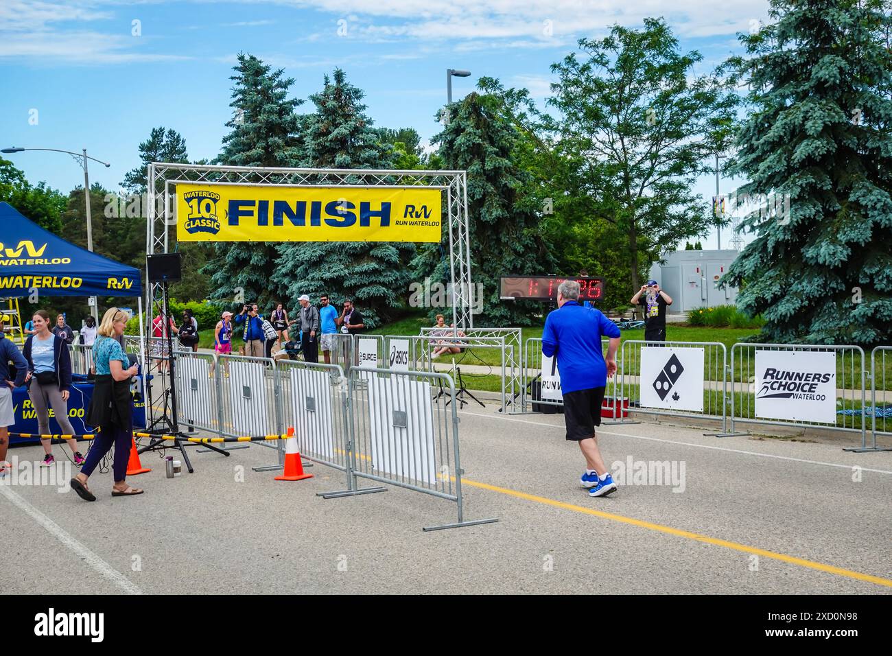The back view of an elderly white male runner nearing the finish line ...