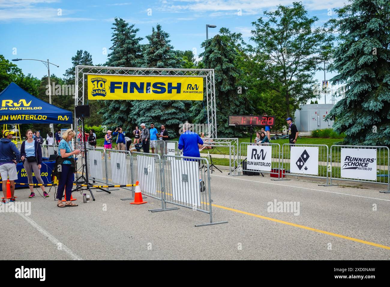 Finish line of a small 10K race with the last few runners crossing ...