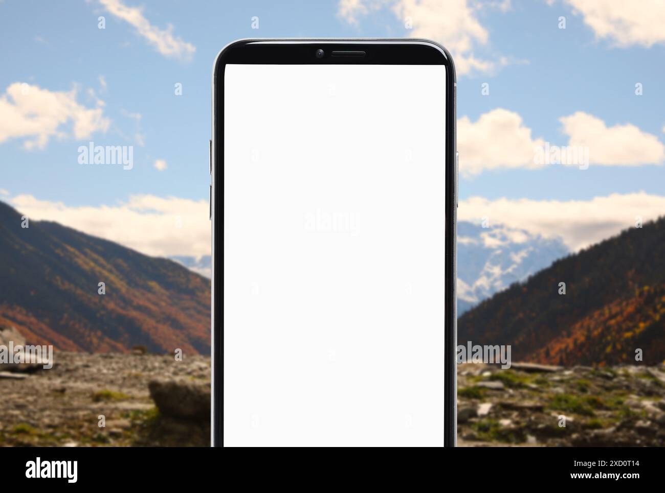 Mobile phone with empty screen against mountain landscape. Space for ...