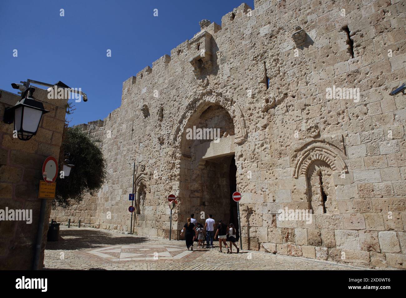 People enter Zion Gate, one of eight gates to the Old City of Jerusalem ...